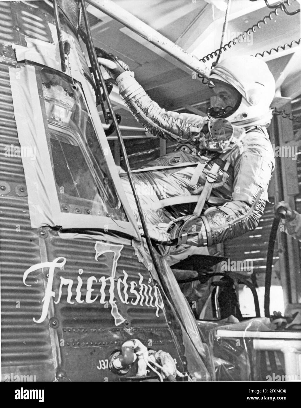 Astronaut John H. Glenn, Jr. enters the Friendship 7 spacecraft during ...