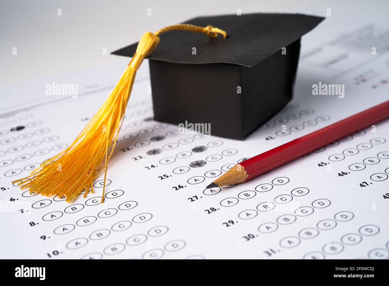 Graduation gap hat and pencil on answer sheet background, Education ...