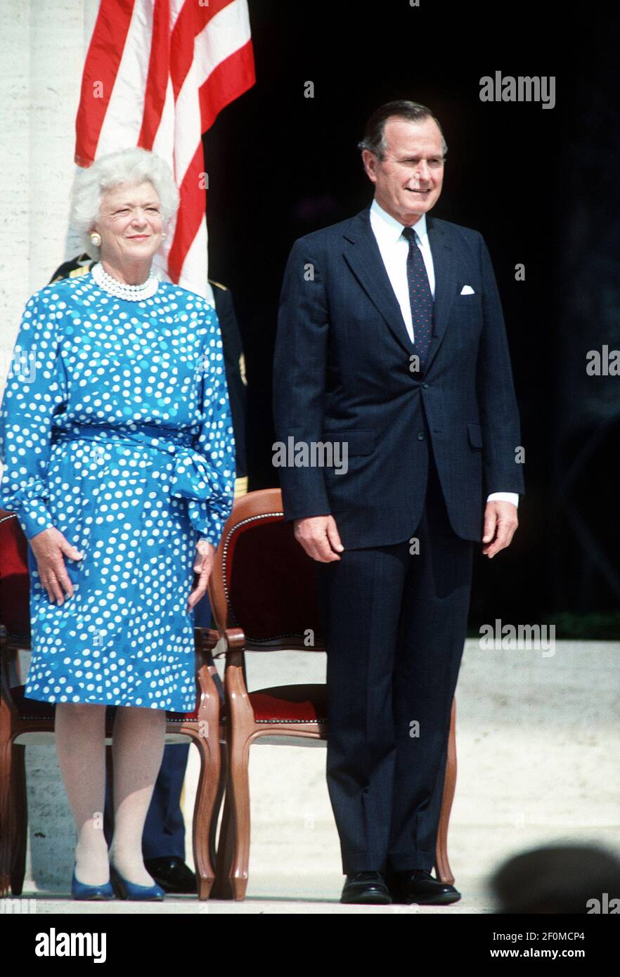 President George H.W. Bush and Barbara Bush stand during a ceremony at ...