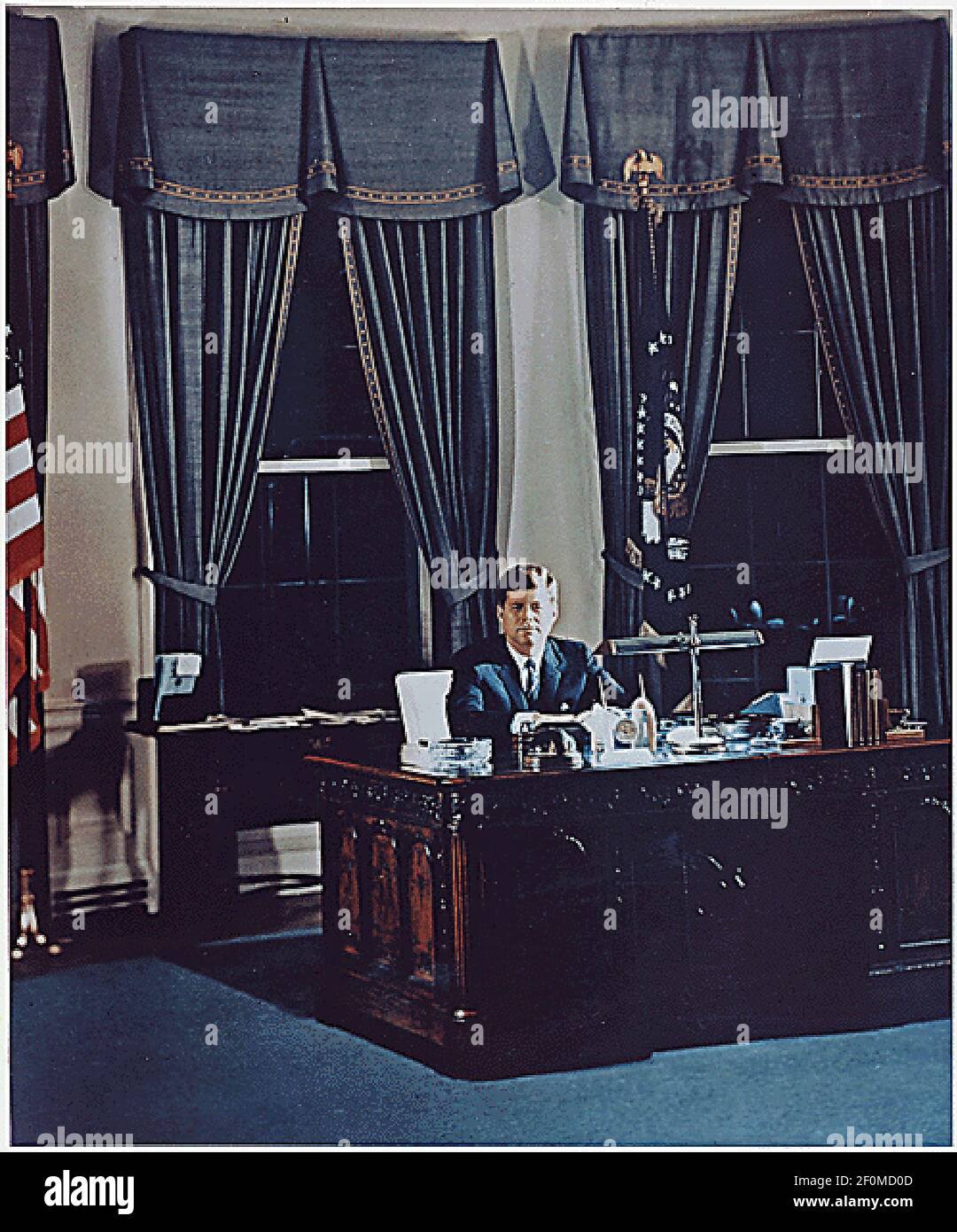 Portrait of United States President John F. Kennedy at his desk in the ...