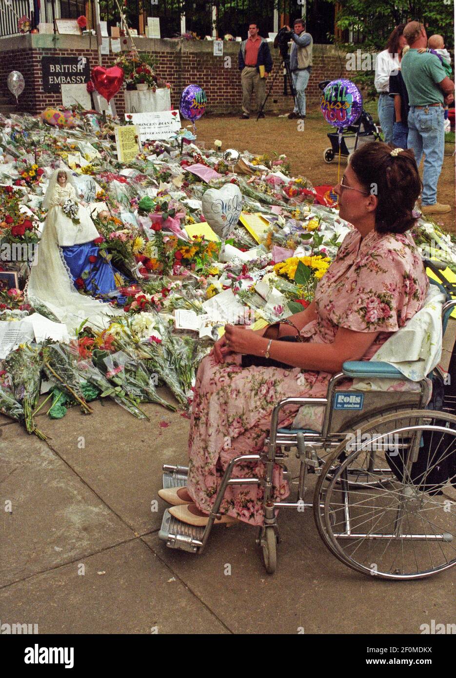 Danette Byrne of Hampstead, MD looks at the flowers and gifts left in ...
