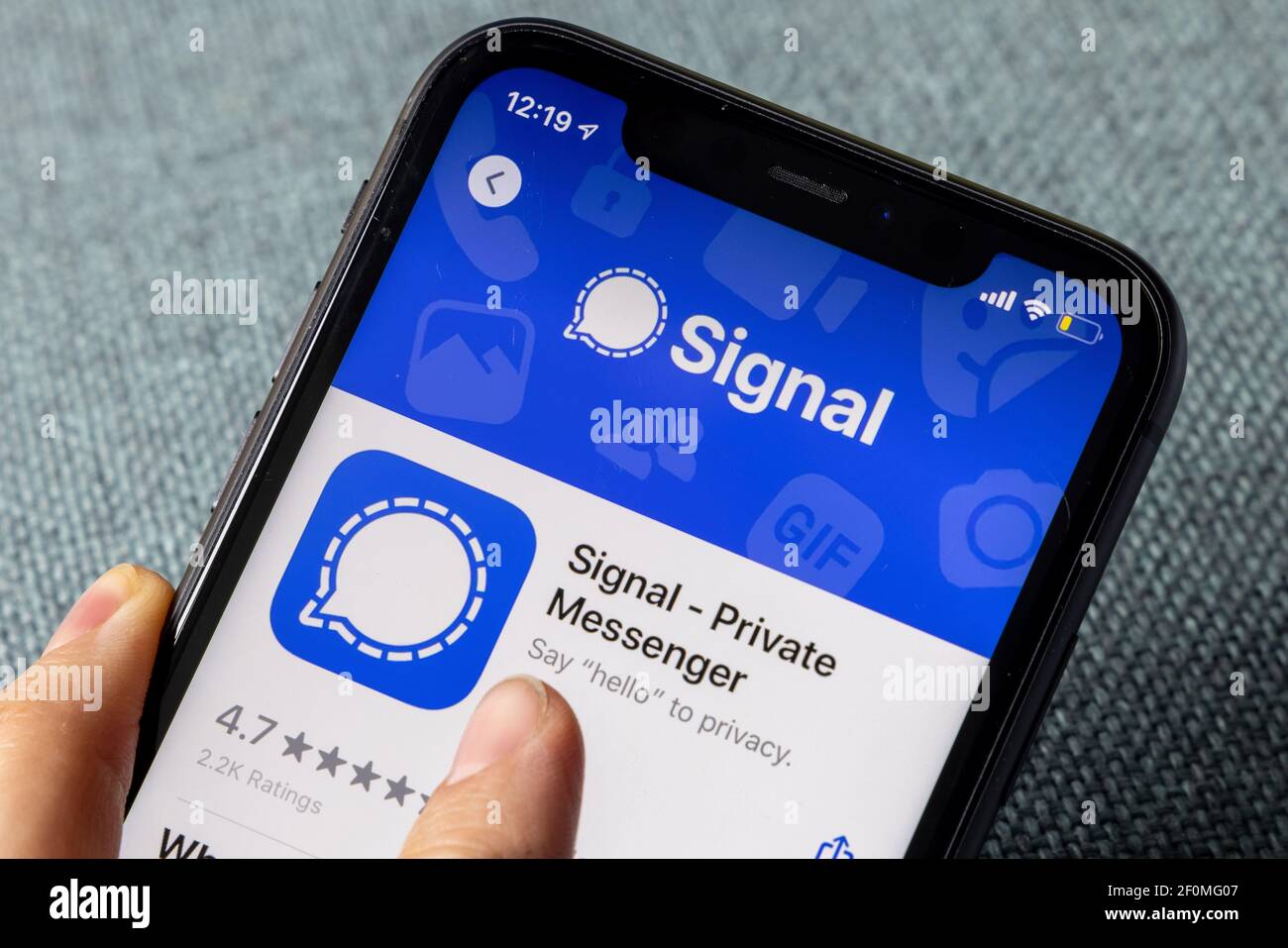 iPhone 11 on blue background with new messenger app Signal logo and ...