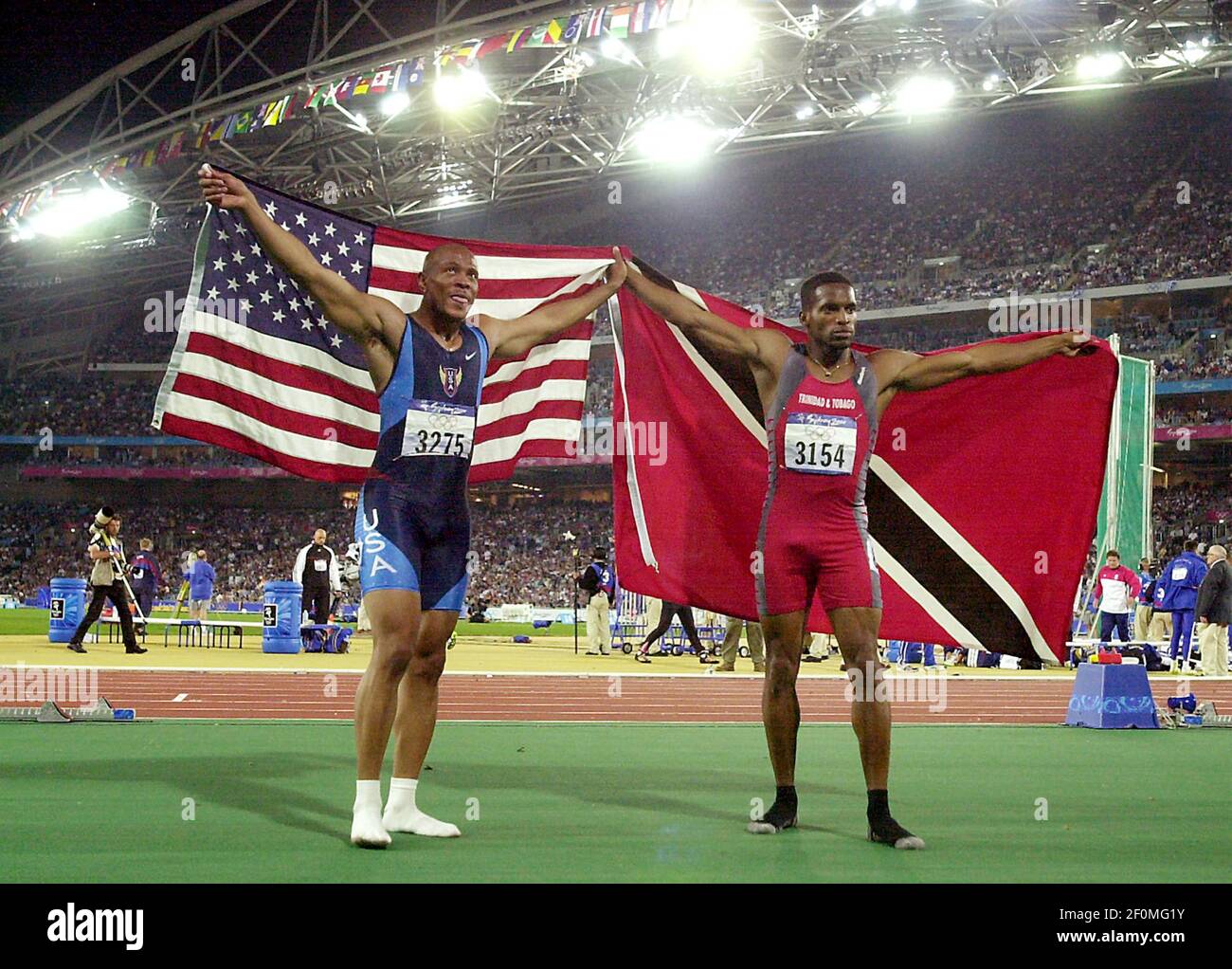 USA's Maurice Greene holds the American flag aloft as Trinidad's Ato ...