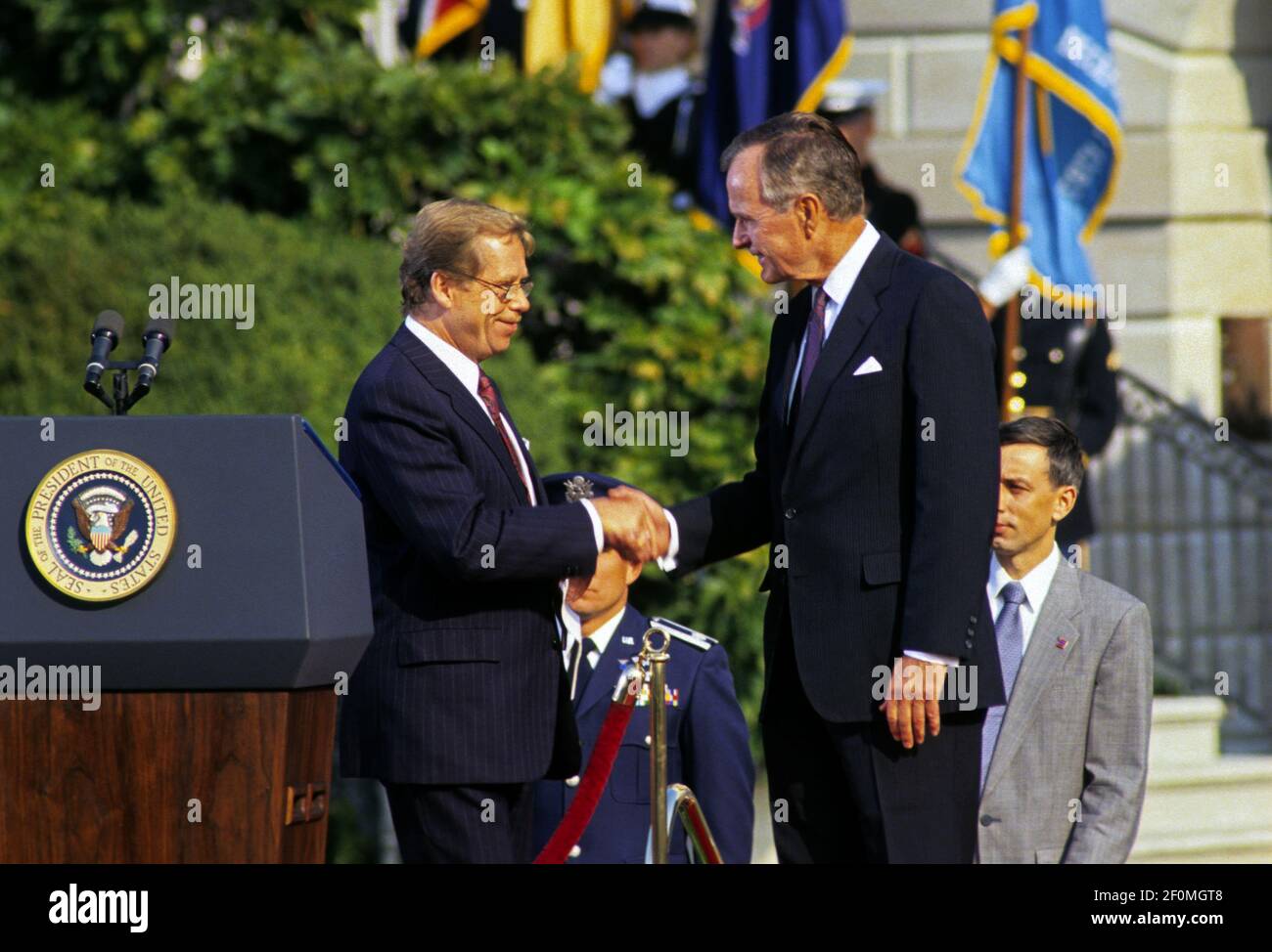 United States President George H.W. Bush, right, shakes hands with ...