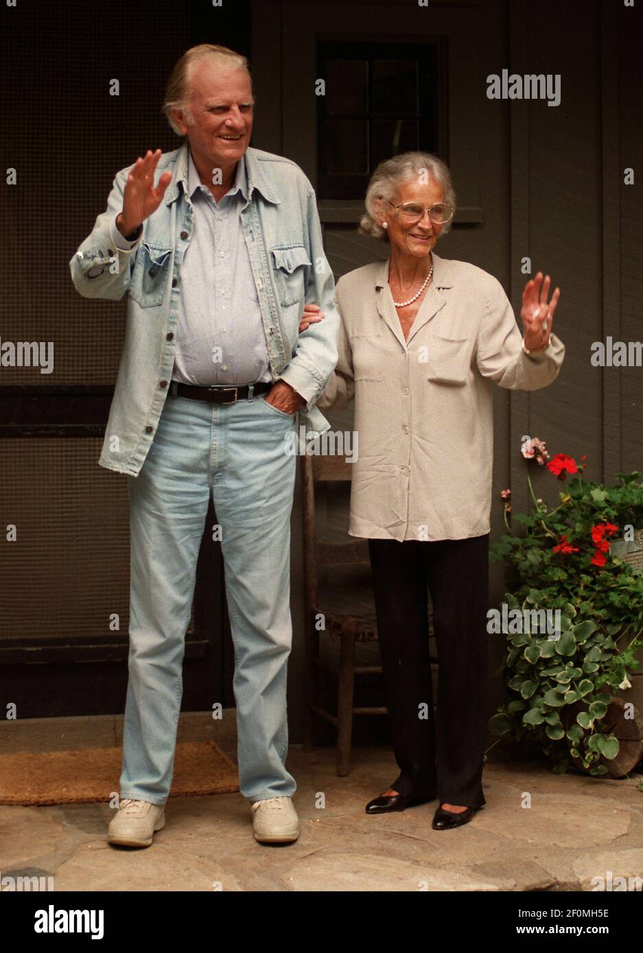 The Rev. Billy Graham and his wife Ruth wave goodbye to the media ...