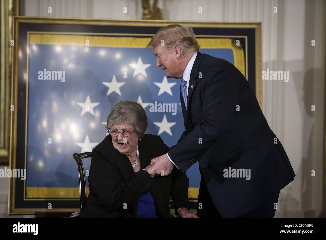 President Donald Trump helps Pauline Connor, widow of 1st Lt. Garlin ...