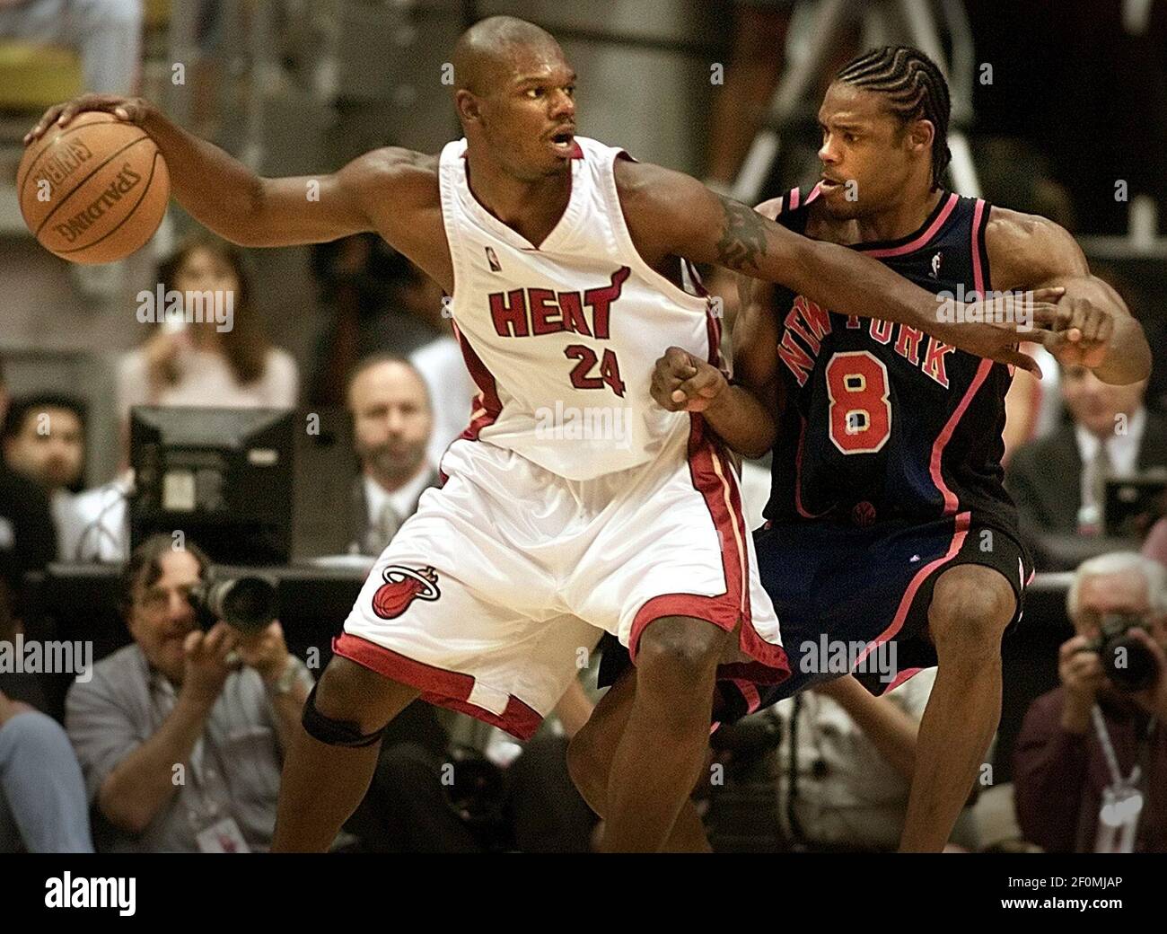 The Miami Heat's Jamal Mashburn, left, is defended by Latrell Sprewell ...