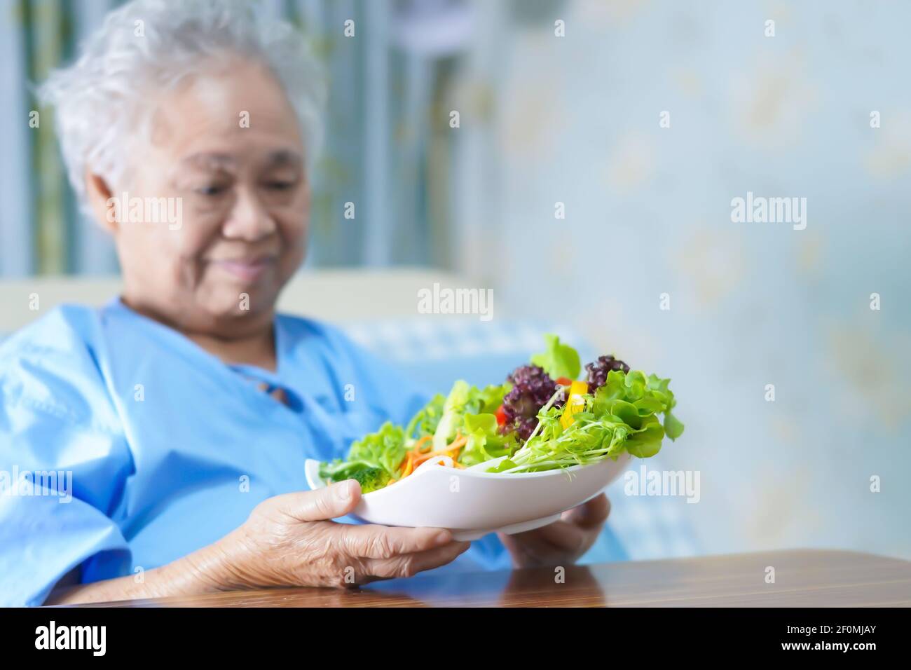 Asian senior or elderly old lady woman patient eating breakfast ...