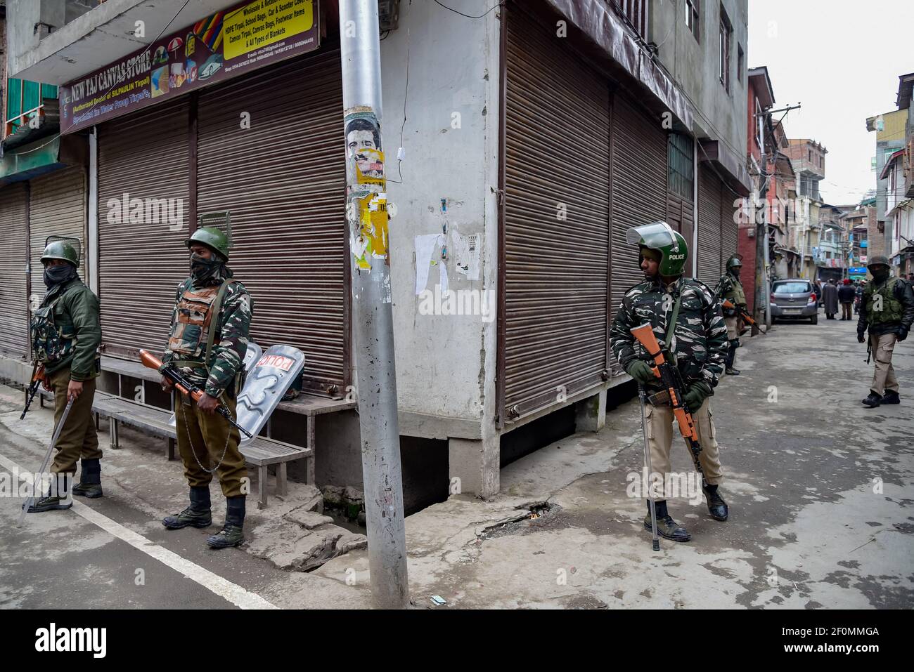 Indian paramilitary troopers are seen standing on guard outside home of ...