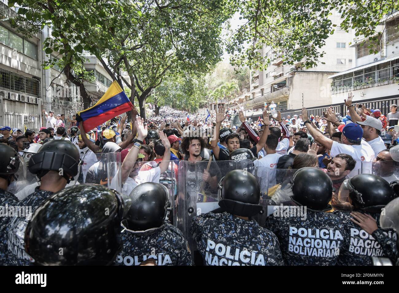Demonstrators seen facing at Bolivarian National Police (PNB) officers ...