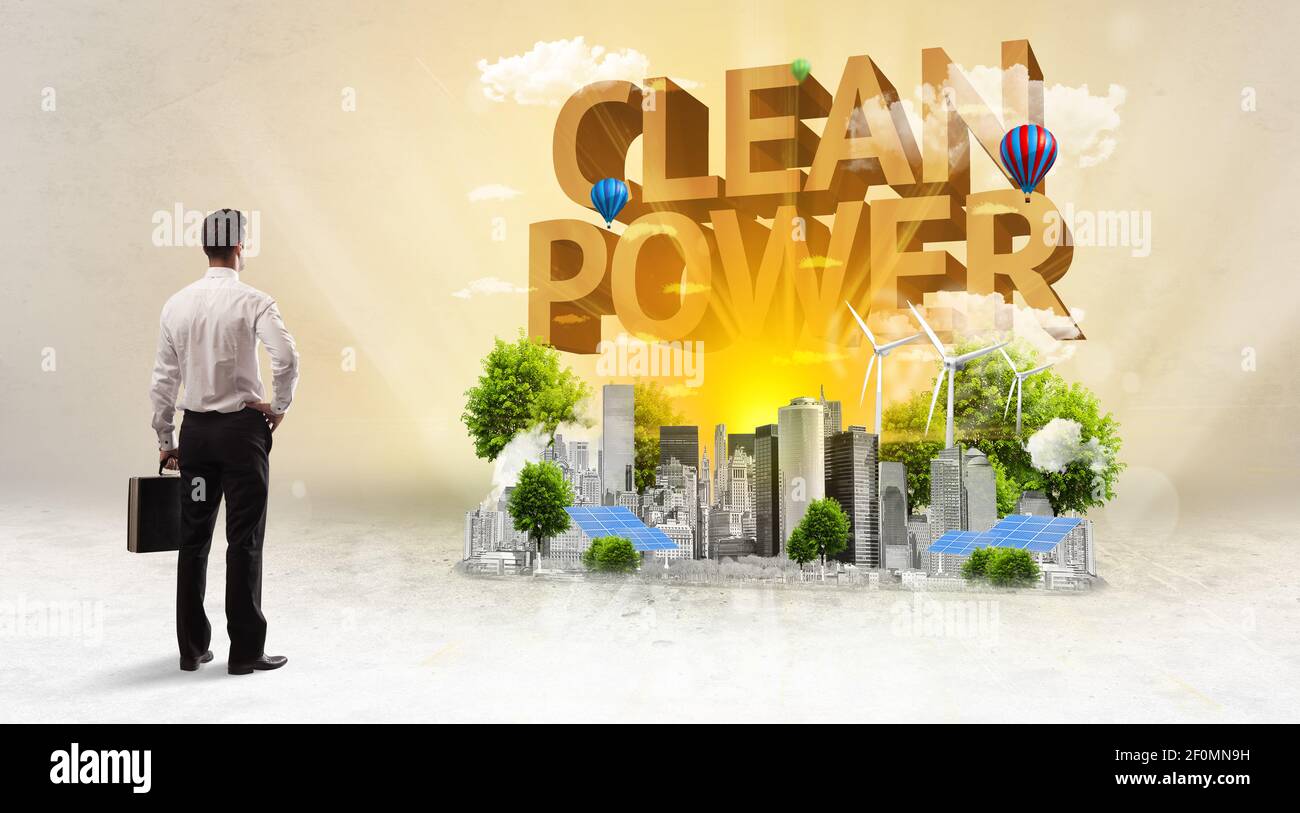 Rear view of a businessman standing in front of CLEAN POWER inscription ...