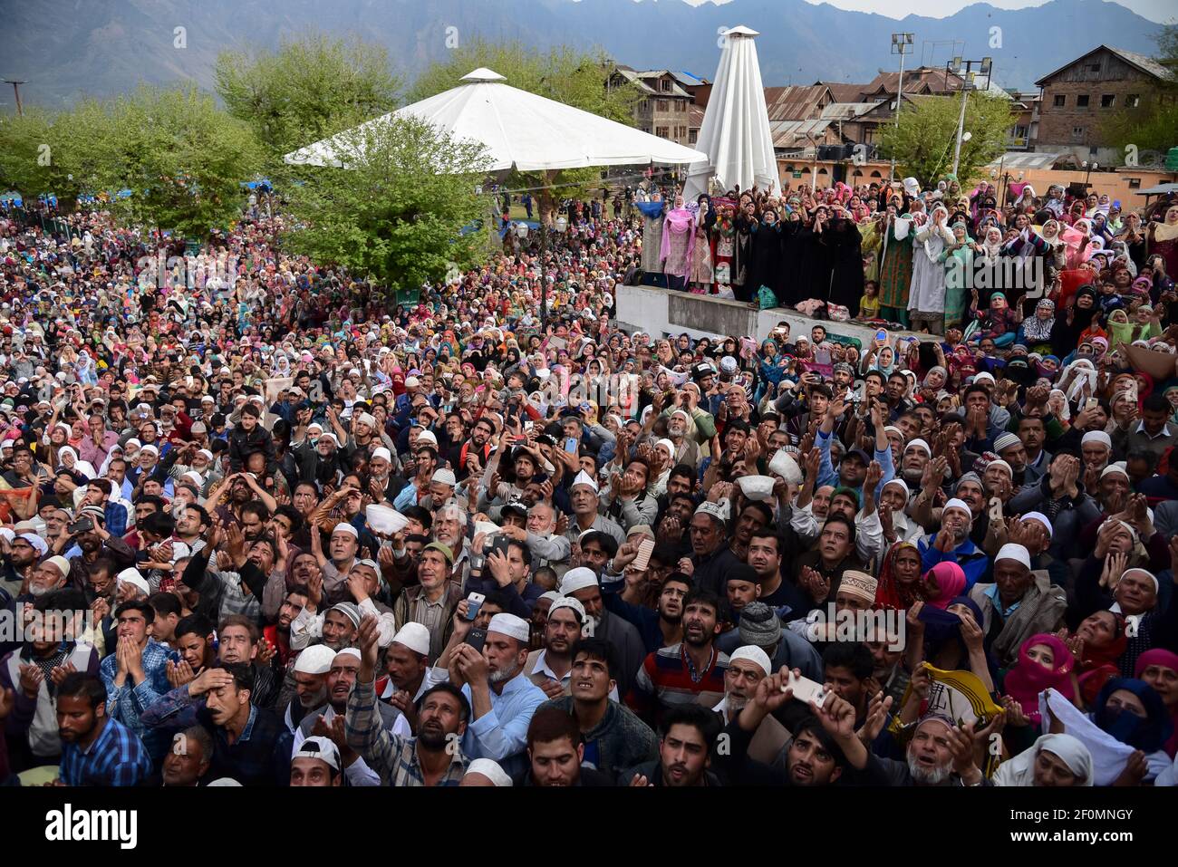 Kashmiri Muslim devotees seen raising their hands while beseeching for ...
