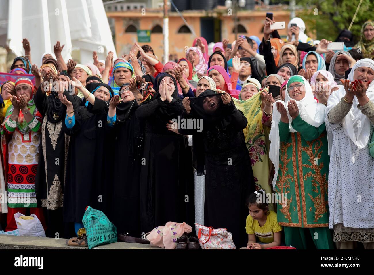 Kashmiri Muslim devotees seen raising their hands while beseeching for ...