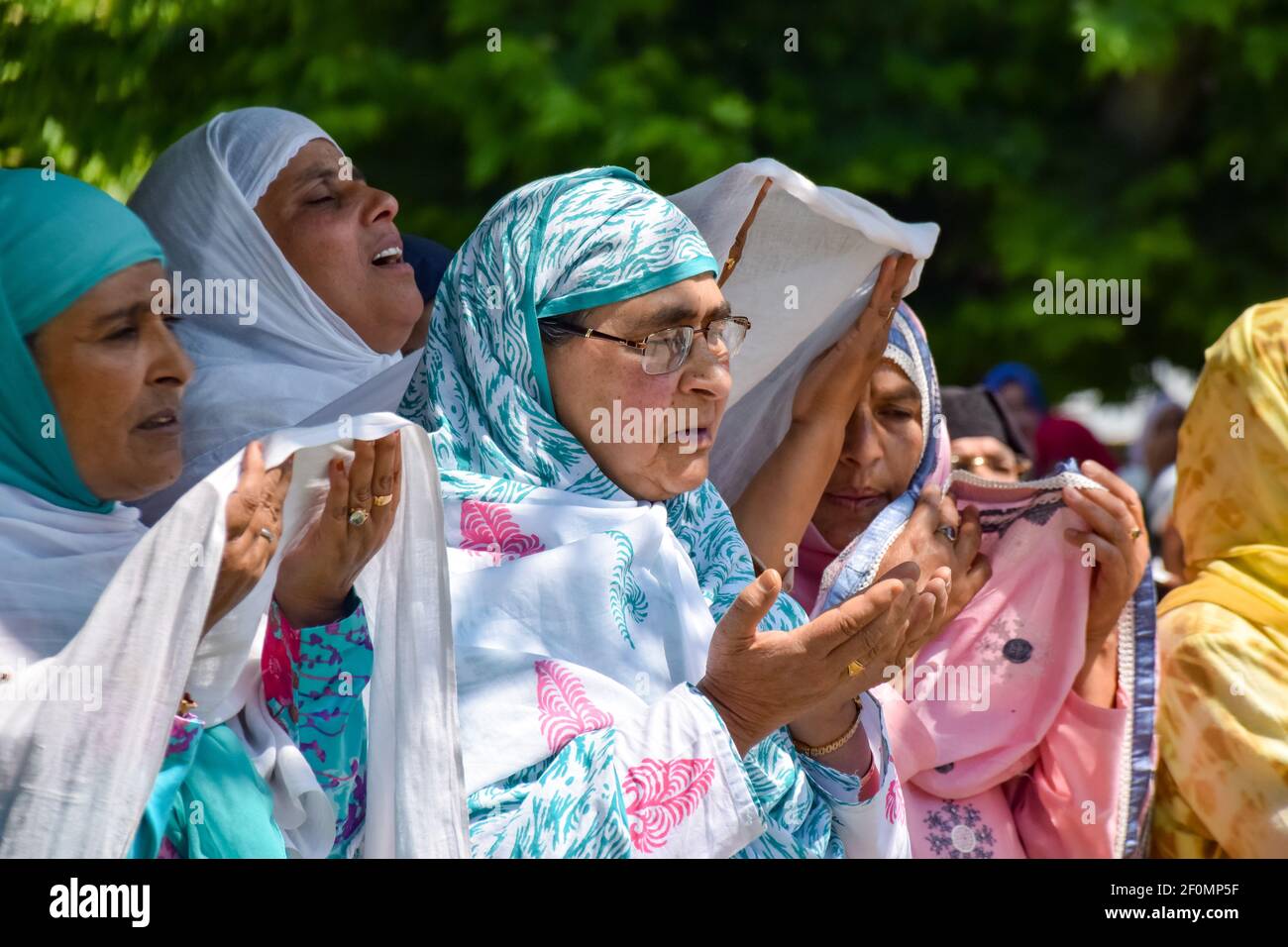 Kashmiri Muslim devotees are seen raising their hands to seek for ...