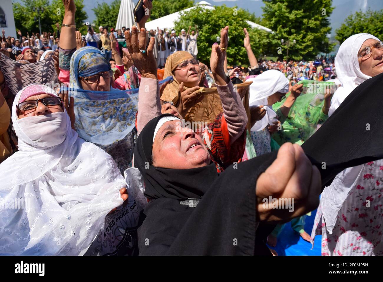 Kashmiri Muslim devotees are seen raising their hands to seek for ...