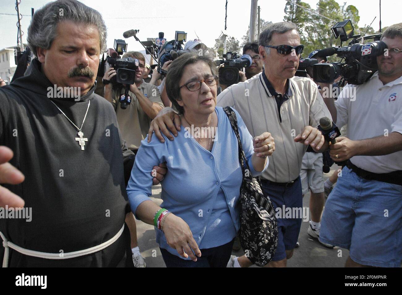 Mary Schindler, the mother of Terri Schiavo, is led to the Woodside ...