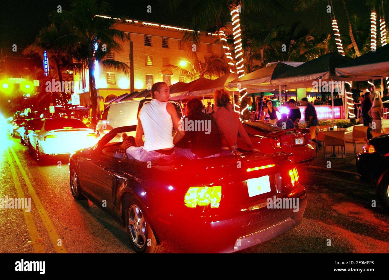 Cars cruise Ocean Drive in Miami during spring break in a 2003 file image. (Photo by Roberto ...