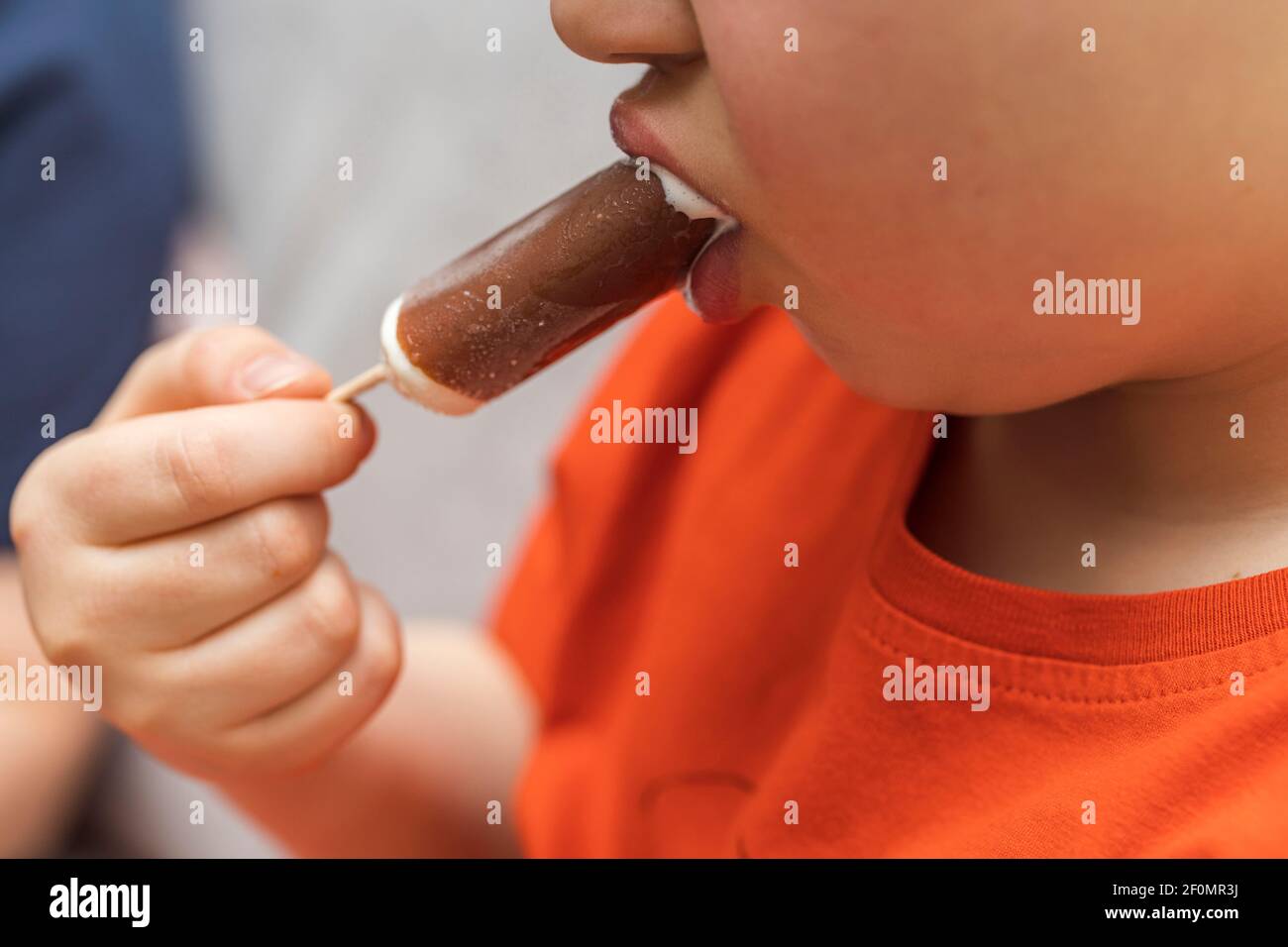 Close up view of child biting ice cream. Health concept background ...