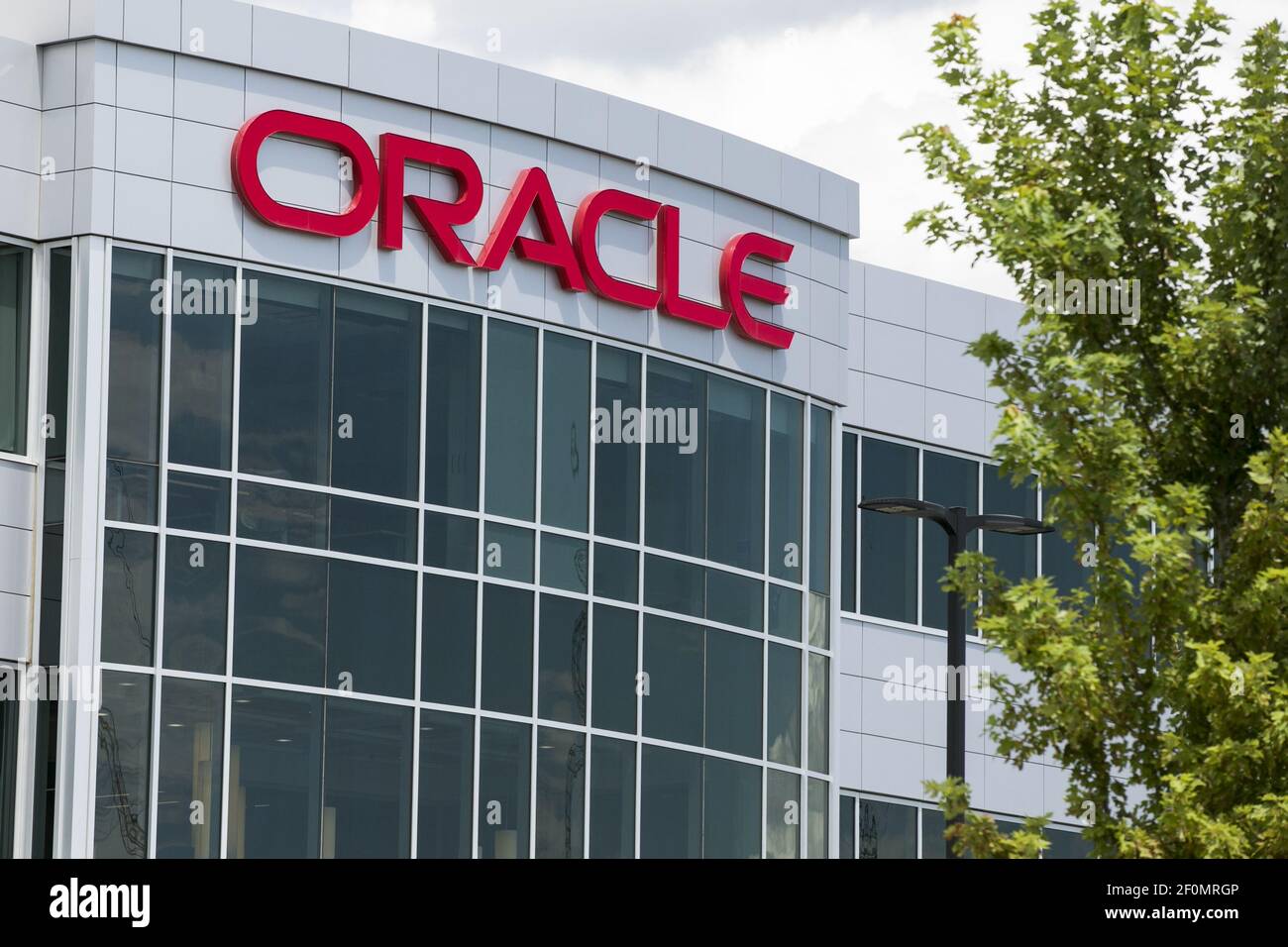 A logo sign outside of a facility occupied by the Oracle Corporation in ...