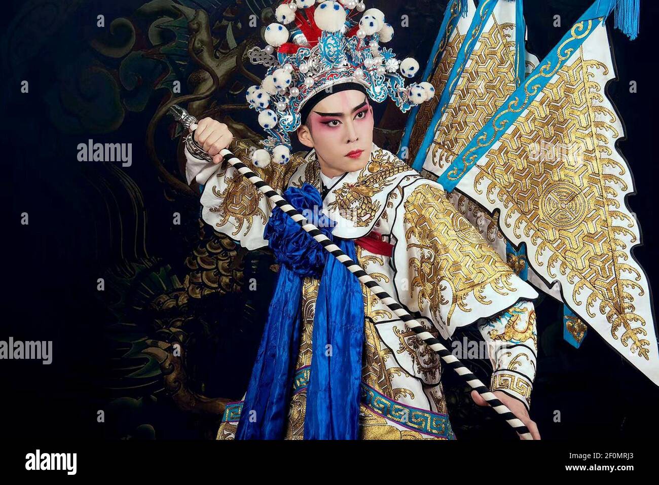 A tourist wearing Sichuan Opera costume poses for photos in Chengdu ...