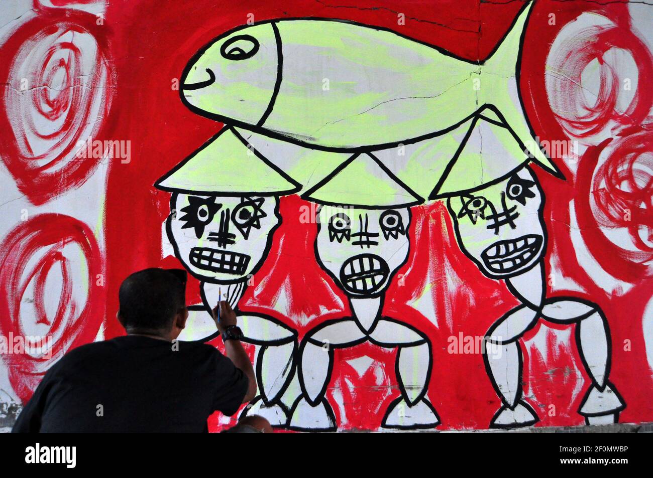 A painter in Palu, Central Sulawesi, Indonesia painted mural art on ...