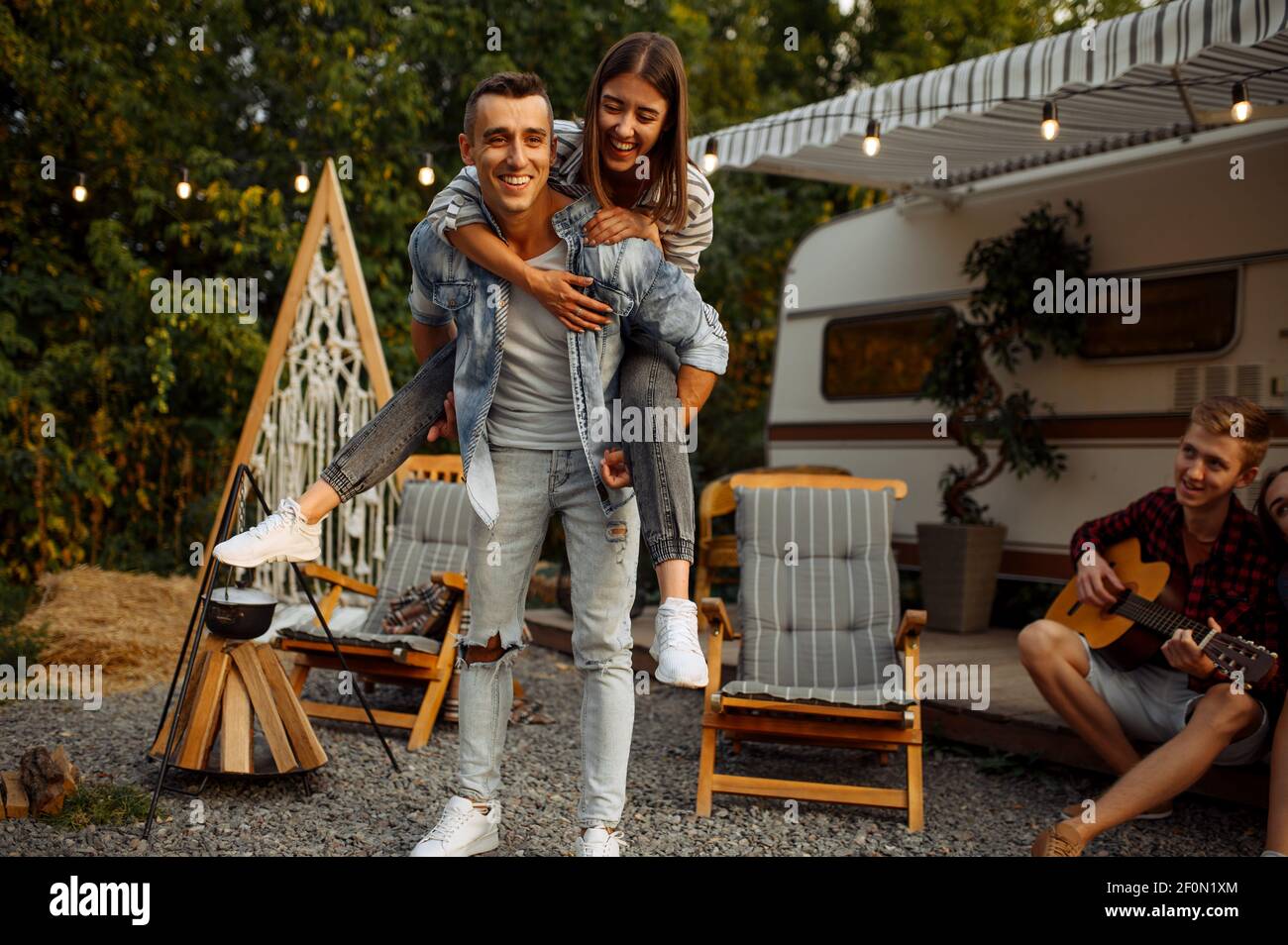 Smiling friends having fun on picnic at camping Stock Photo - Alamy