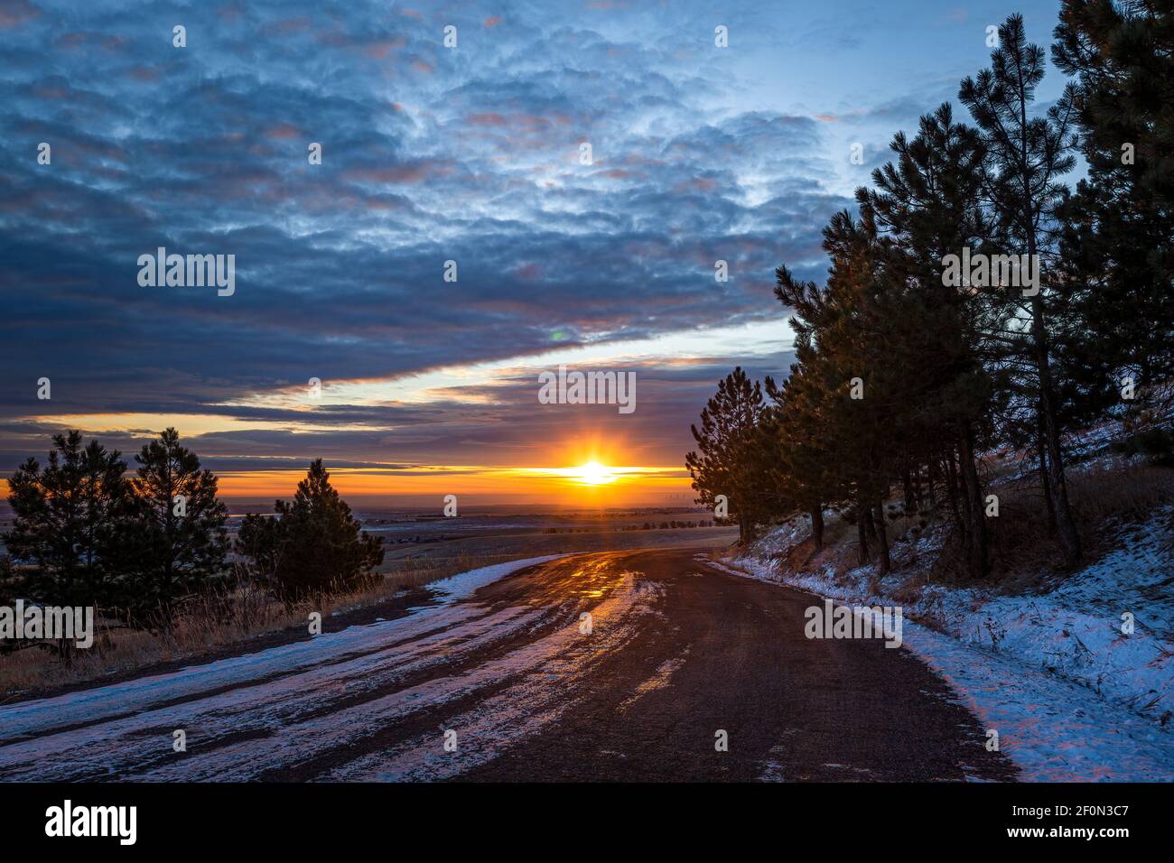 Sun peeking through clouds at sunrise Stock Photo - Alamy