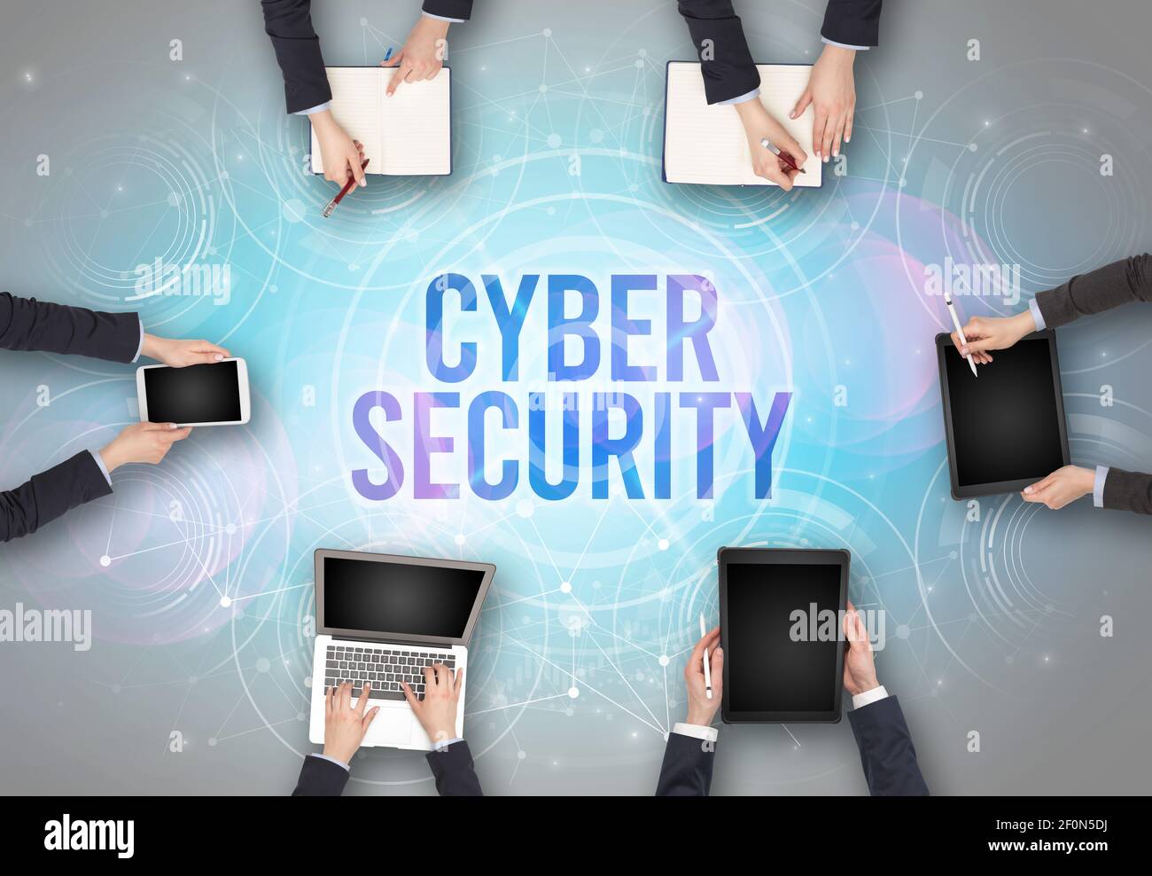 Group of people in front of a laptop with CYBER SECURITY insciption ...