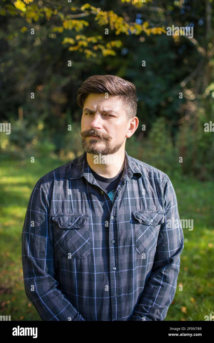 Portrait of inquisitive man thinking outdoors Stock Photo - Alamy