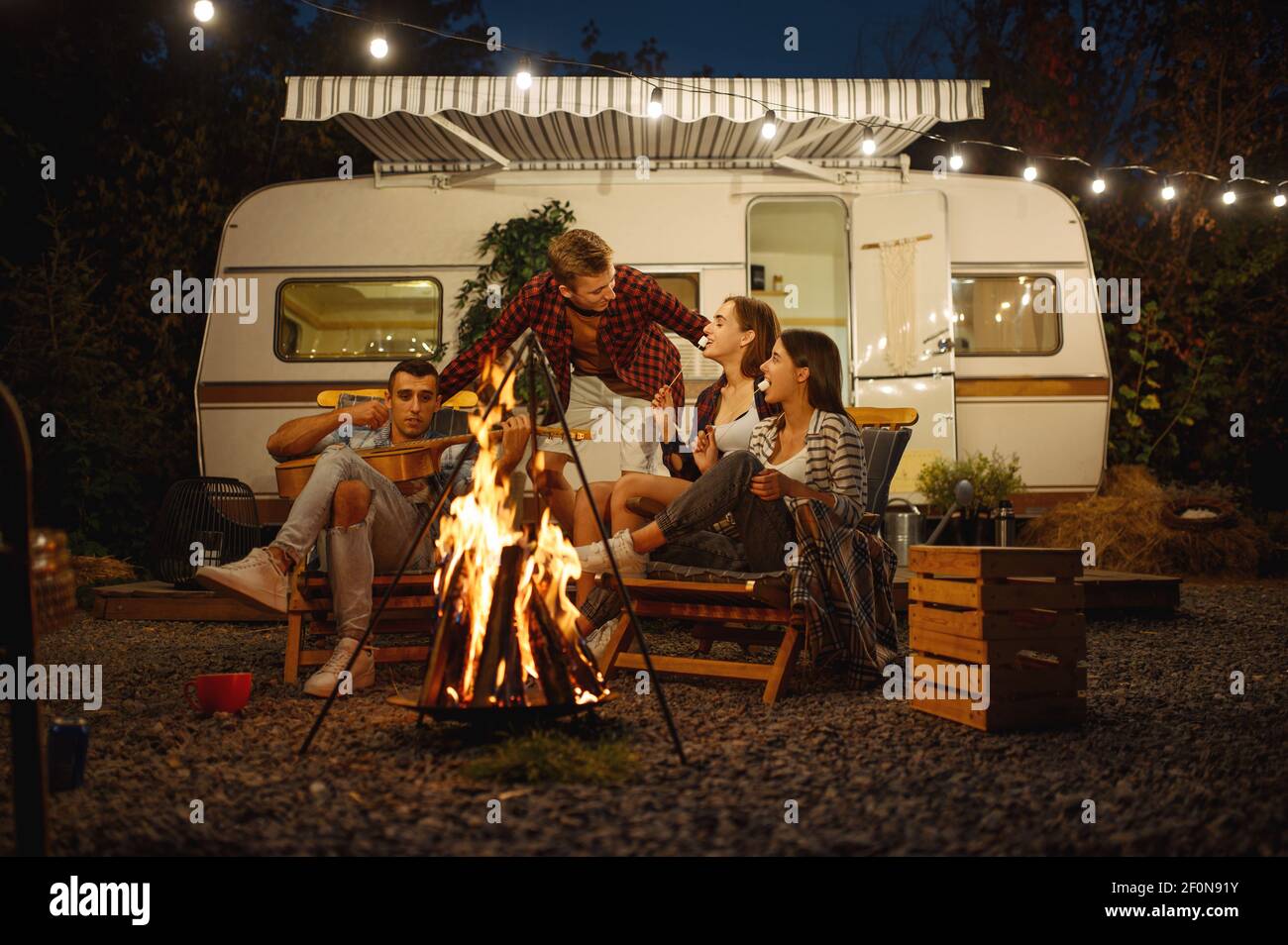 Friends cooking on campfire, picnic at camping Stock Photo - Alamy