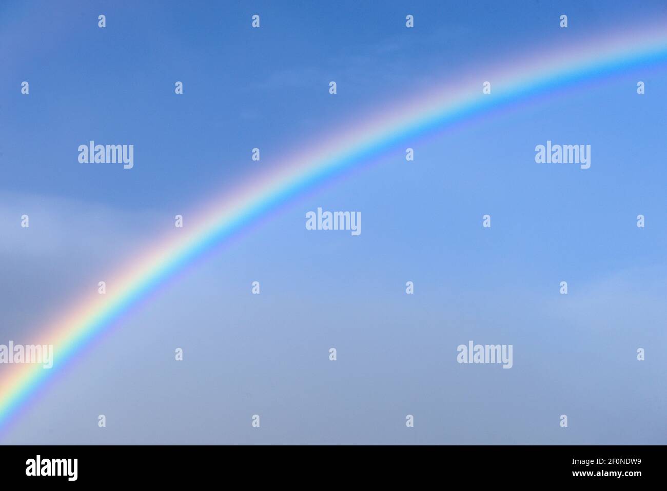 Detail of a rainbow curve on a blue sky background Stock Photo - Alamy