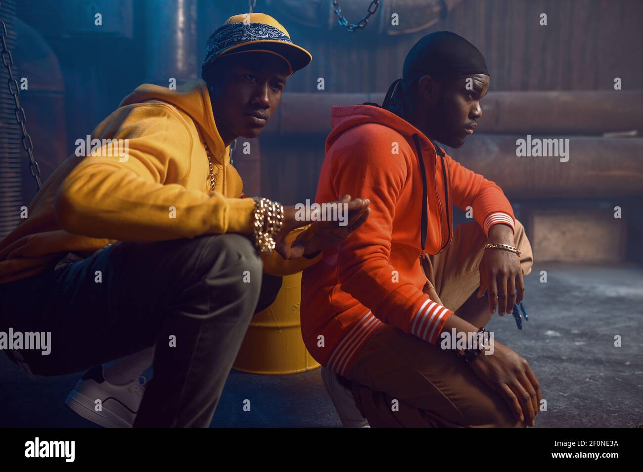 Two stylish rappers poses in studio Stock Photo - Alamy