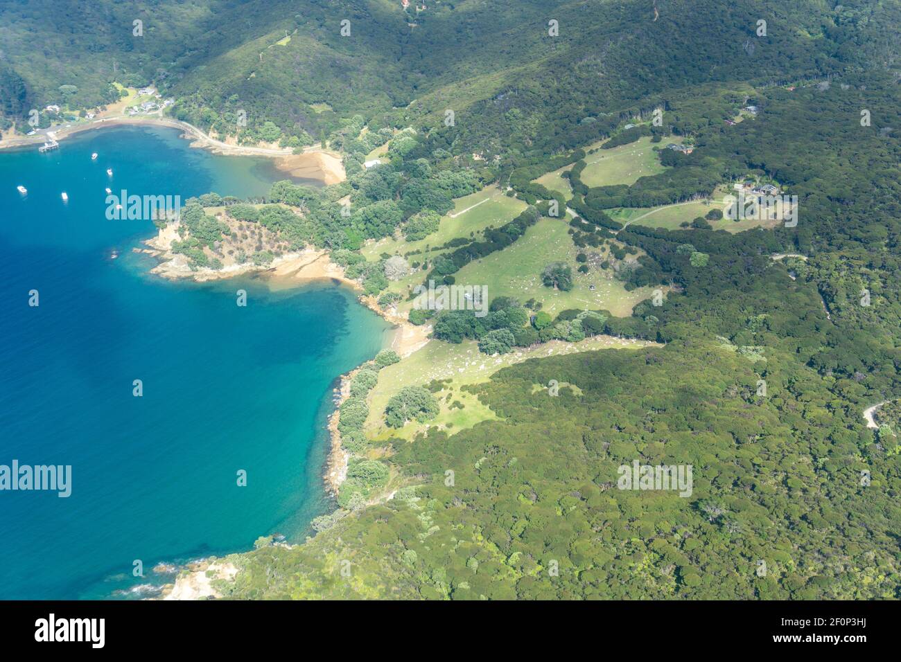Aerial image of bush-clad landscape and coastal bay area of Great ...