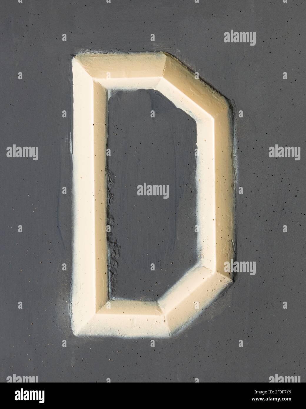 Beige letter A inverse relief in grey painted concrete Stock Photo - Alamy