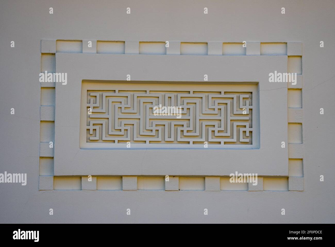 Stone swag and carvings are seen above the windows and columns of the ...