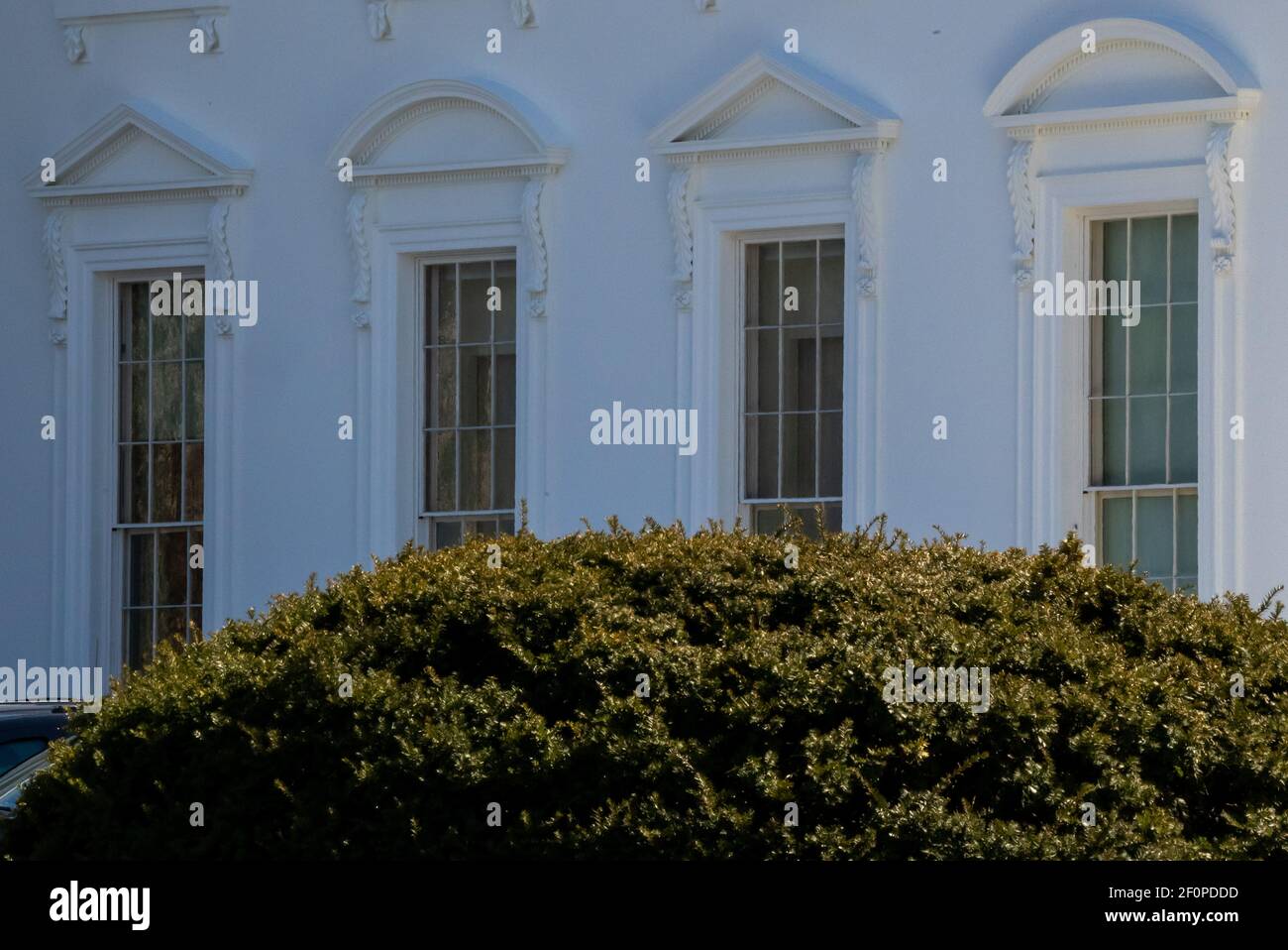 Stone swag and carvings are seen above the windows and columns of the ...