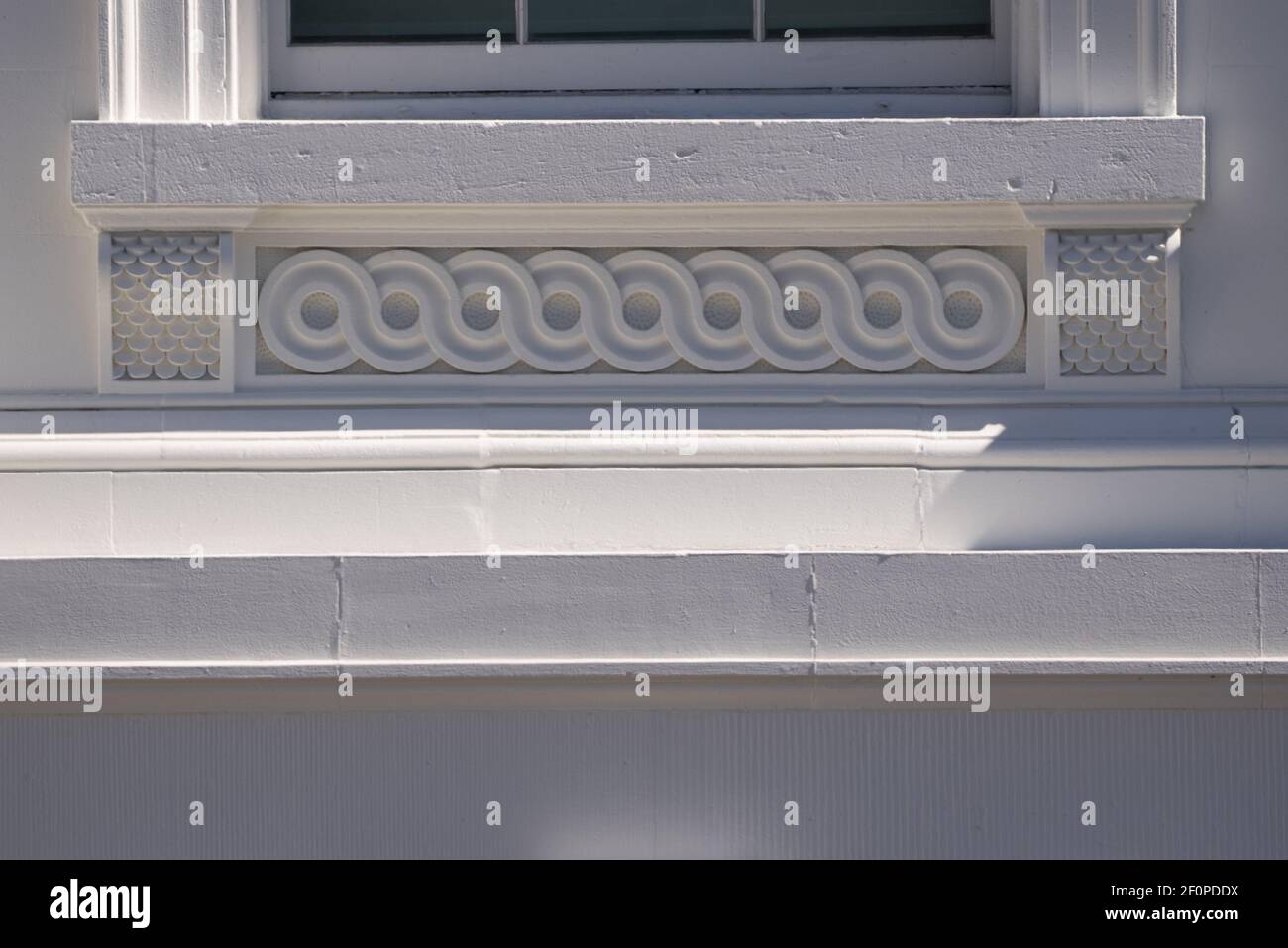 Stone swag and carvings are seen above the windows and columns of the ...