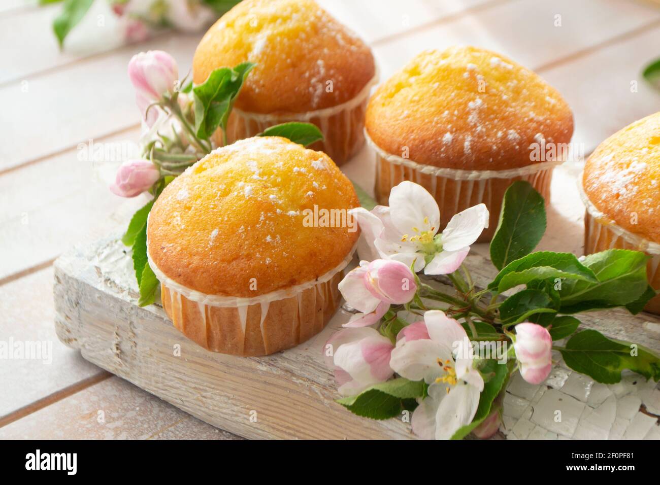 Muffins and spring flowers on a wooden shabby table Stock Photo - Alamy
