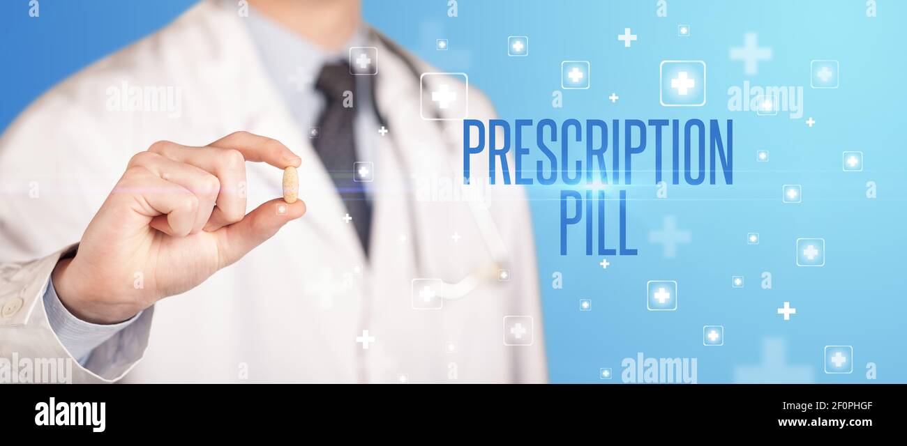 Close-up of a doctor giving a pill with PRESCRIPTION PILL inscription ...