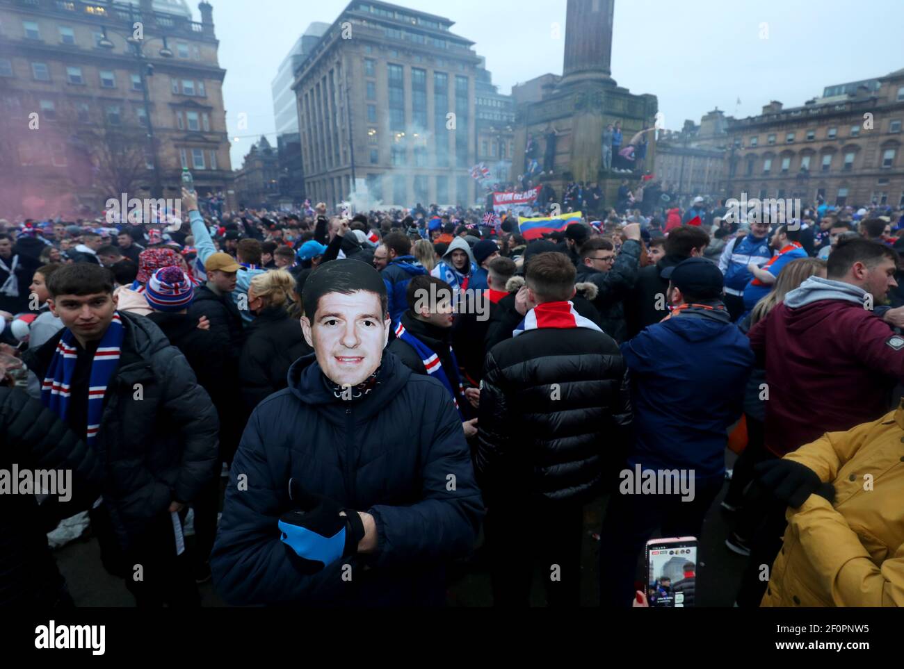 A Rangers fan wearing a Steven Gerrard mask celebrates in George Square ...