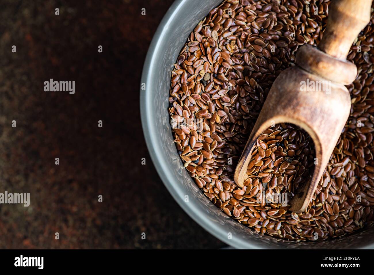 Bowl with organic flax seeds as a healthy cooking concept on concrete ...