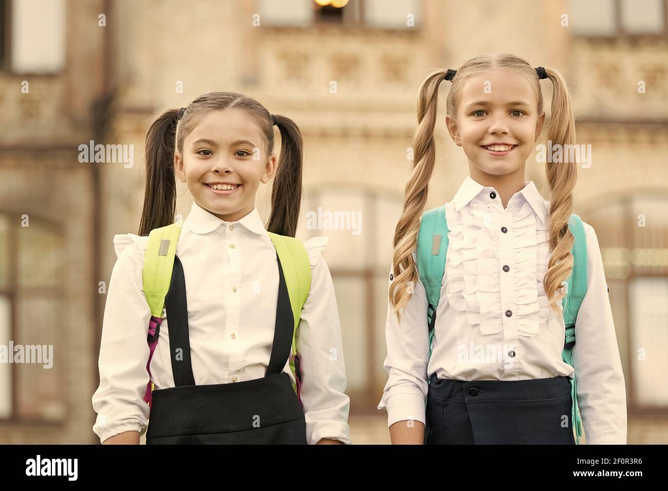 Cute schoolgirls with long ponytails looking charming. Ending of school ...