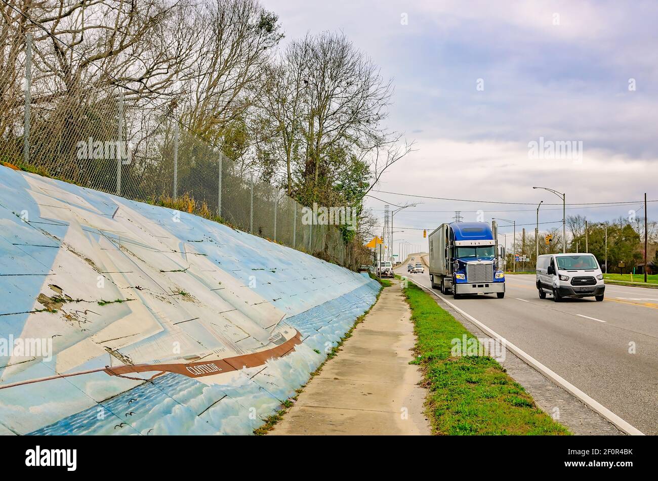 Traffic drives past a mural of the Clotilda slave ship on Africatown ...