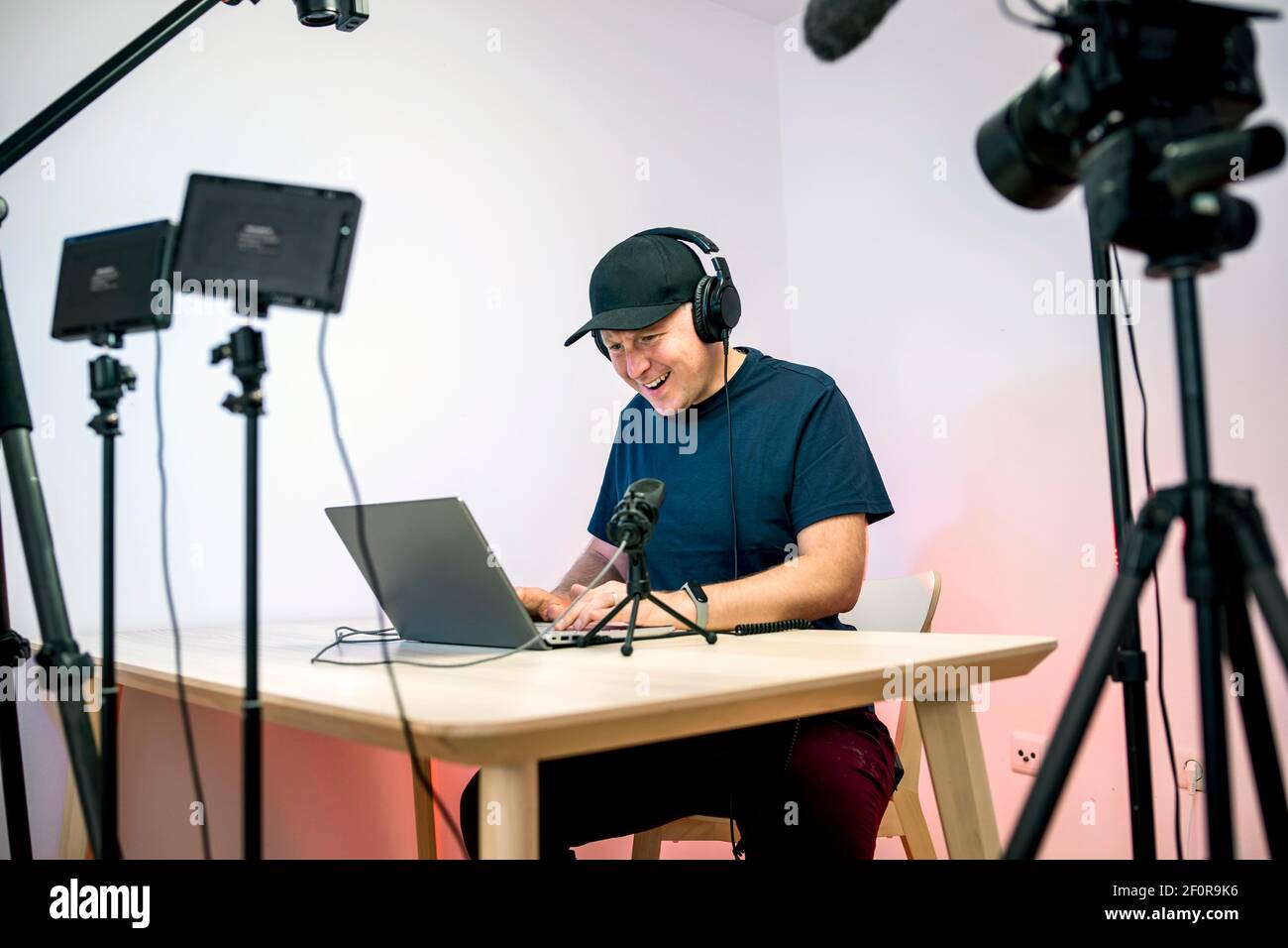 Gamer, streamer, or Youtuber streaming and recording in his home studio ...