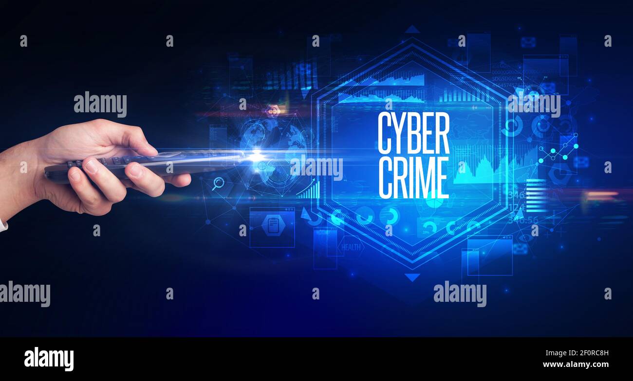 hand holding wireless peripheral with CYBER CRIME inscription, cyber ...