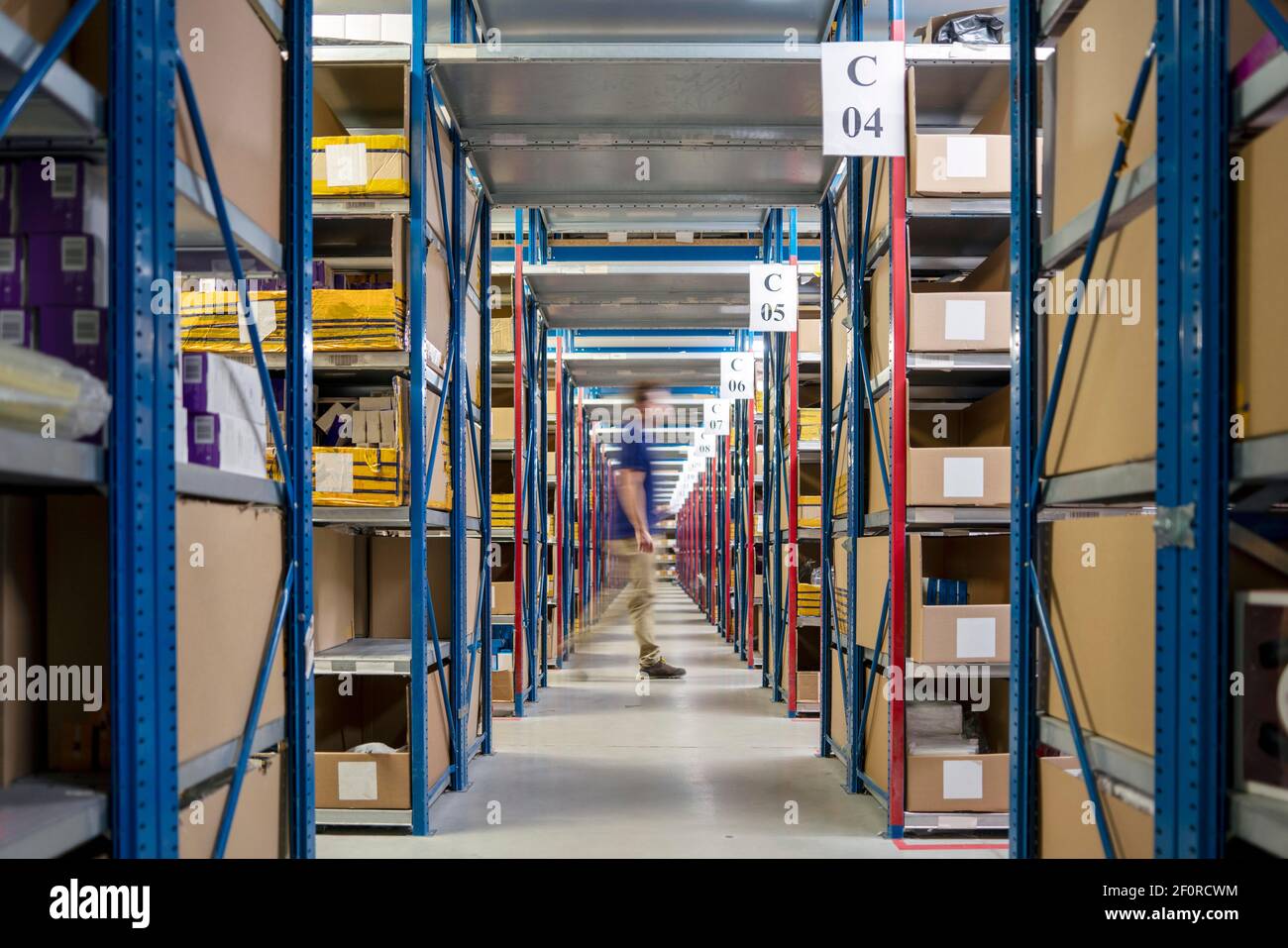 Long corridor in big, modern warehouse full of goods Stock Photo - Alamy