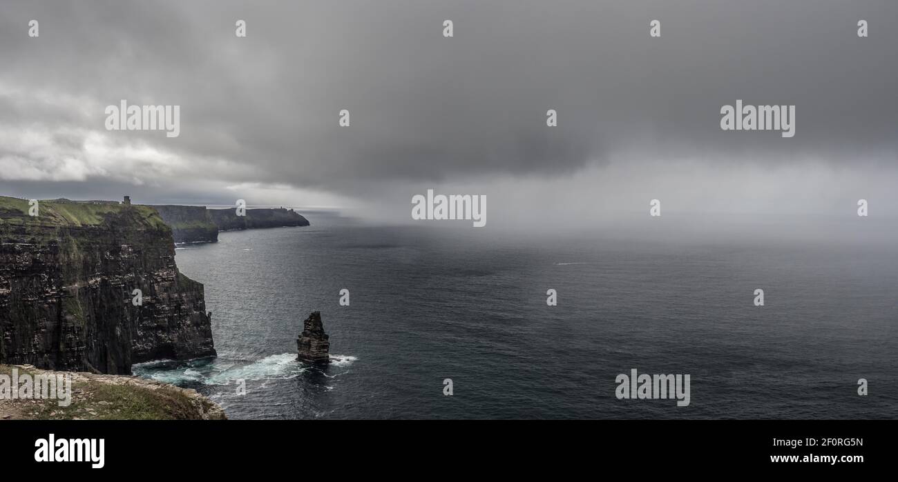 Thunderclouds and rain showers over cliff and Atlantic Ocean, Cliffs of ...