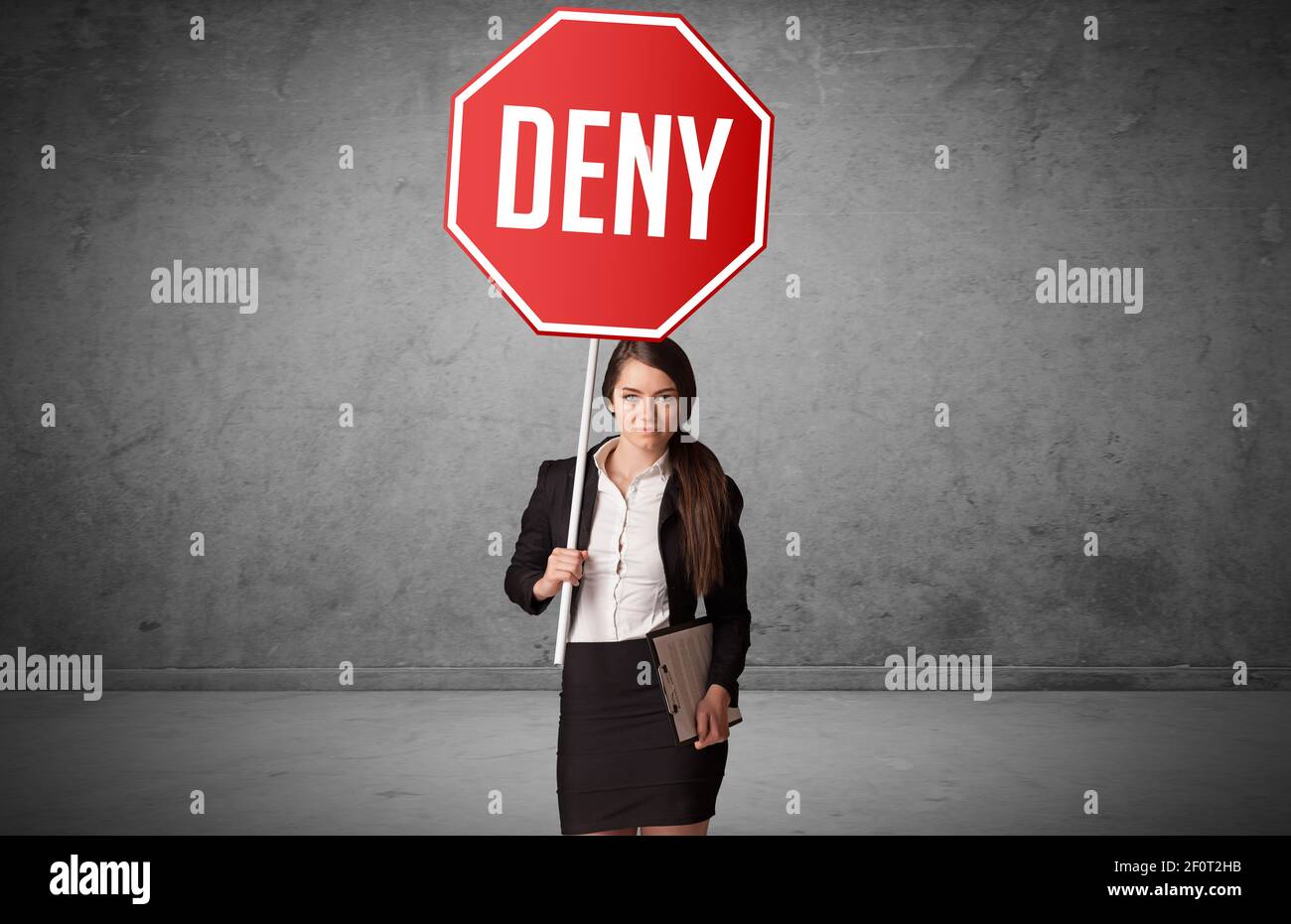 Young business person holding road sign with DENY inscription, new ...