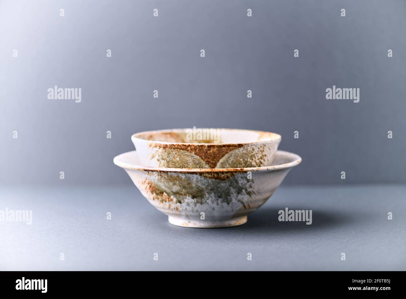 Traditional ceramic bowls on paper background. Copy space Stock Photo ...