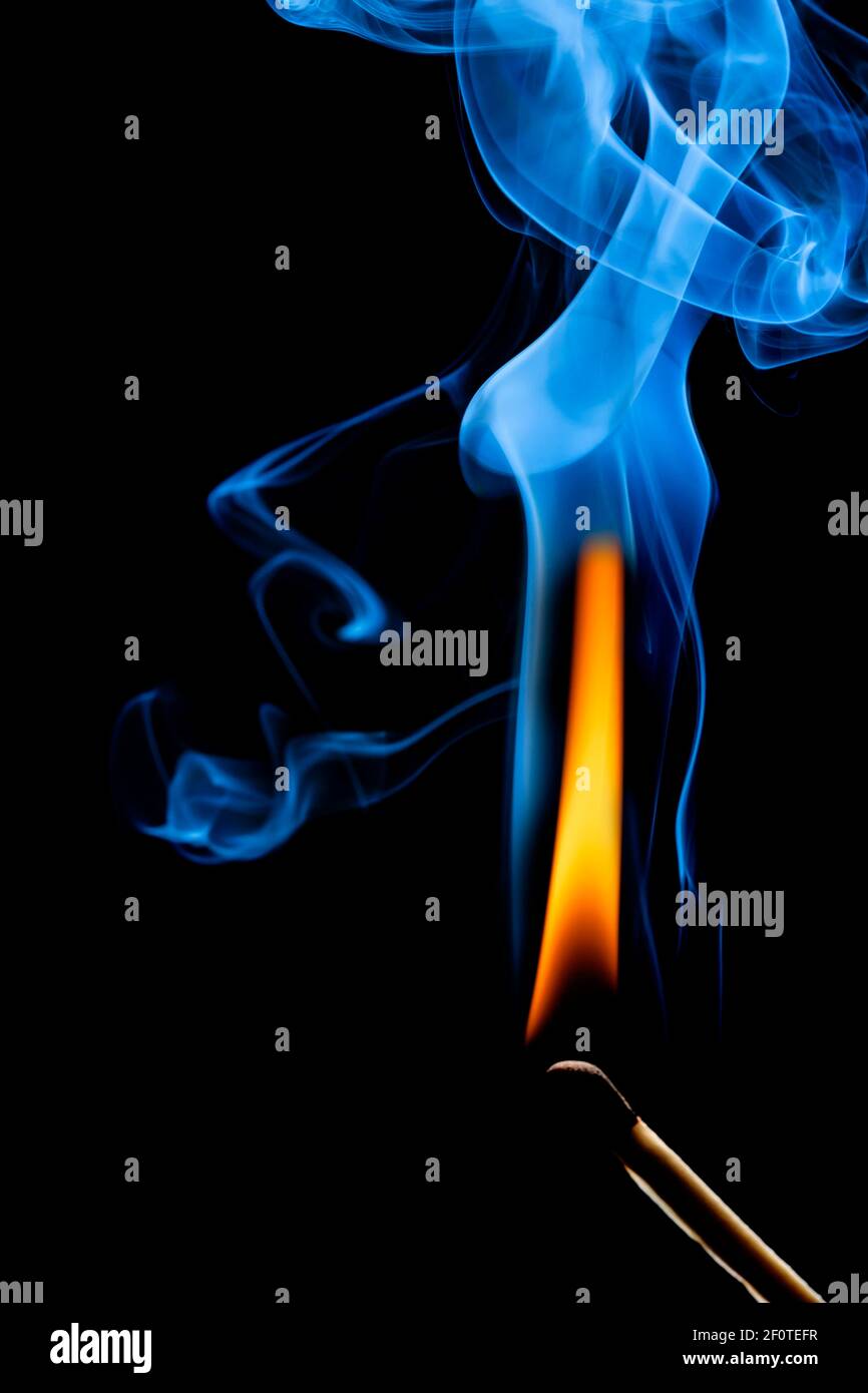Burning match with blue smoke, black background, studio Stock Photo - Alamy